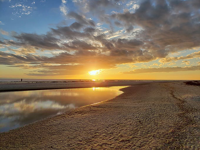 Mother Nature showing off again with a sunset that turns the shoreline into liquid gold—no filter required, just perfect timing.