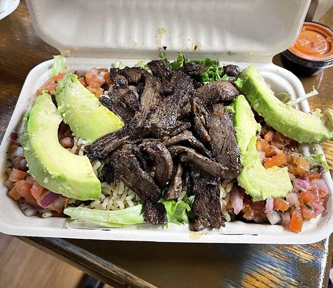 Steak and avocado – nature's perfect partnership – lounging on a bed of rice like they own the place. And they do.