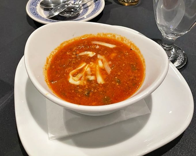 A soup that demands to be savored slowly. That swirl of cream isn't just garnish—it's an invitation to dive in spoon-first.