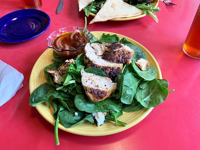 A salad that doesn't feel like punishment. Tender spinach leaves cradle perfectly grilled chicken – proof that healthy eating can still spark joy.