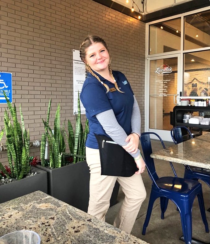 The face of hospitality—where genuine smiles and efficient service combine to make you feel less like a customer and more like a welcome guest.