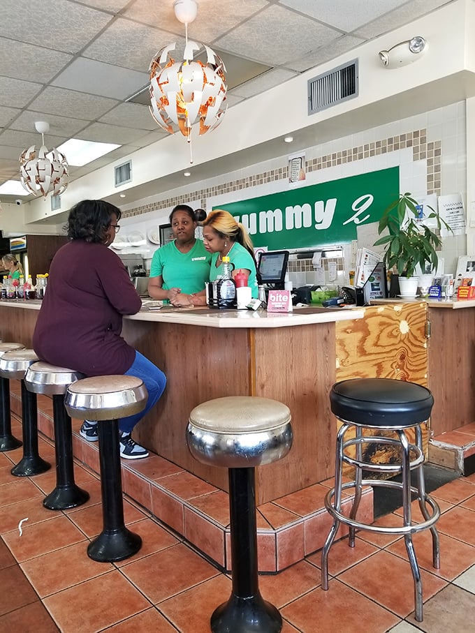 The heart of Yummy 2 – where staff in matching green shirts orchestrate breakfast magic with practiced efficiency.