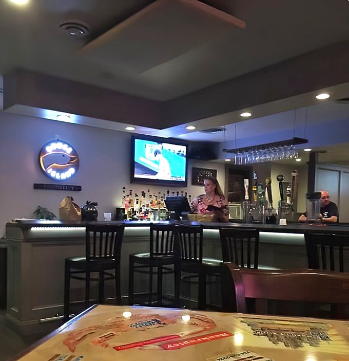 The bar area glows with that perfect amber light that makes everyone look like they're having the best day of their life.