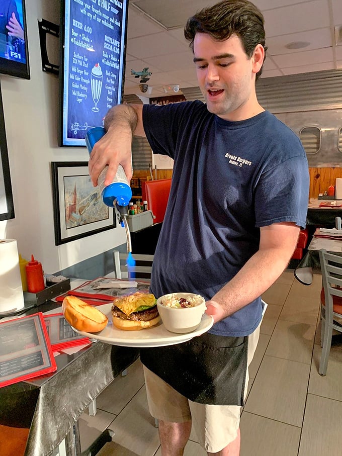 Service with both a smile and a blue milkshake—the kind of multitasking we can all appreciate.