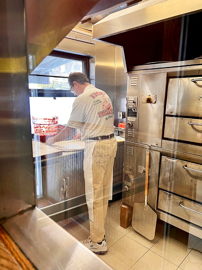 Behind every legendary pizza is someone who knows exactly what they're doing. Decades of pizza wisdom in every careful movement.