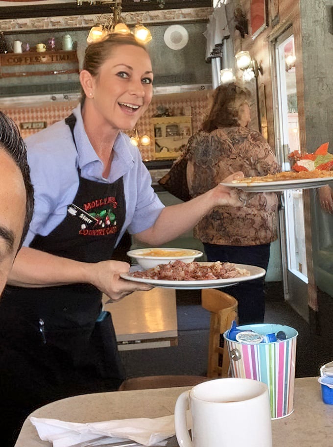 The servers don't just bring food – they deliver happiness with a side of efficiency. That smile says, "Yes, we can bring more syrup."