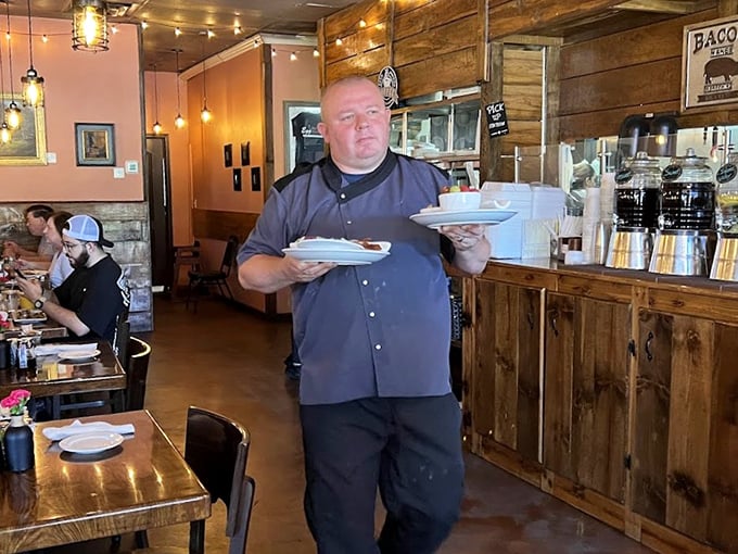 The unsung hero of breakfast—a server balancing multiple plates with the grace of a ballet dancer and the focus of a neurosurgeon.