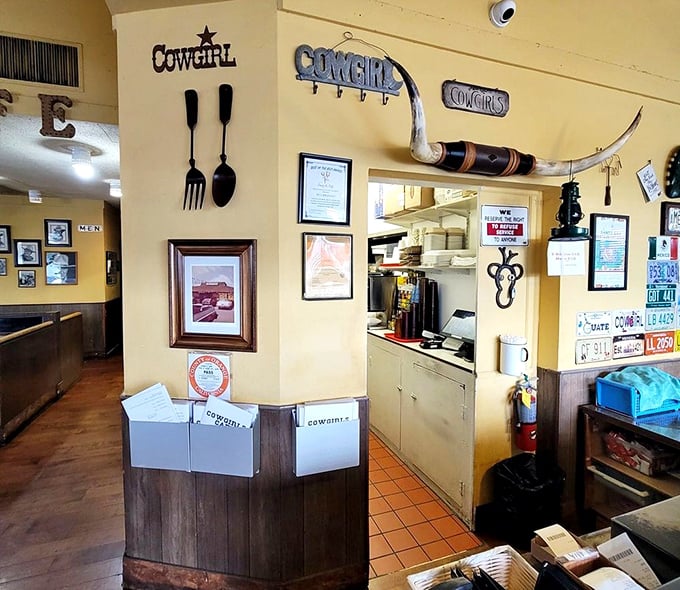 Western-themed decor elements create authentic charm – those giant utensils aren't compensating for anything, they're celebrating everything.