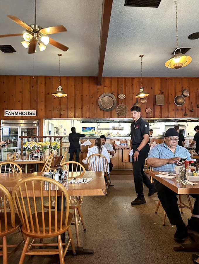 The dining room hums with the perfect breakfast symphony – servers gliding between tables while wooden chairs cradle happy diners.