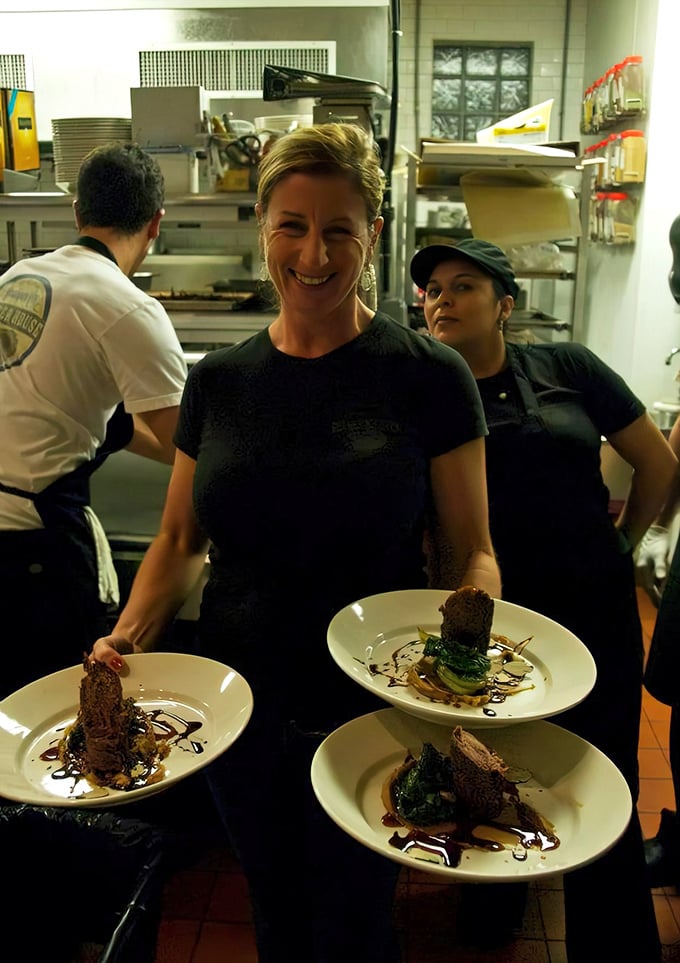 The joy on this server's face says it all: when you love what you serve, it shows in every beautifully plated dish.