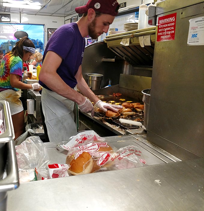 Behind the scenes, the choreographed dance of burger-making unfolds—where tradition and technique meet on a well-seasoned grill.