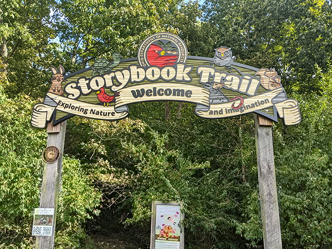The Storybook Trail entrance promises two journeys: one through the woods and another through imagination. Kids collect both.