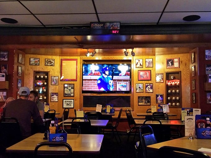 The sports shrine wall, where framed memories and flat screens create the perfect environment for both nostalgia and live action.