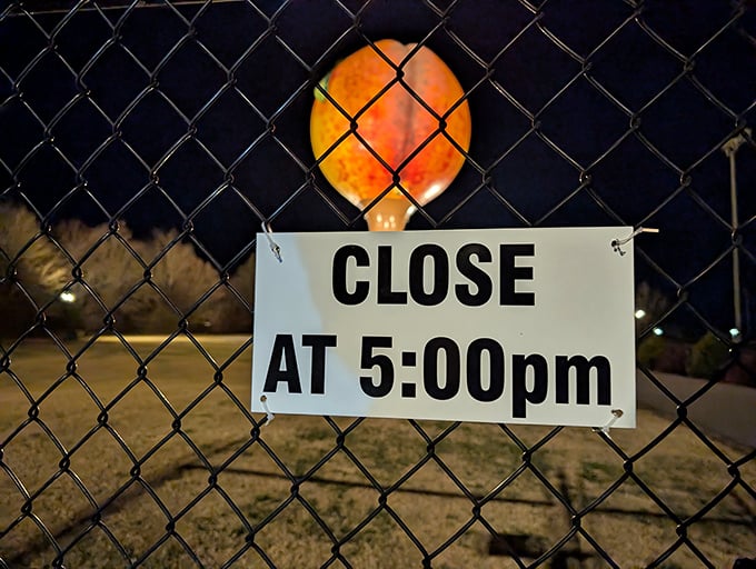 Even at night, the Peachoid stands sentinel, its peachy silhouette visible through the chain-link fence long after closing time.