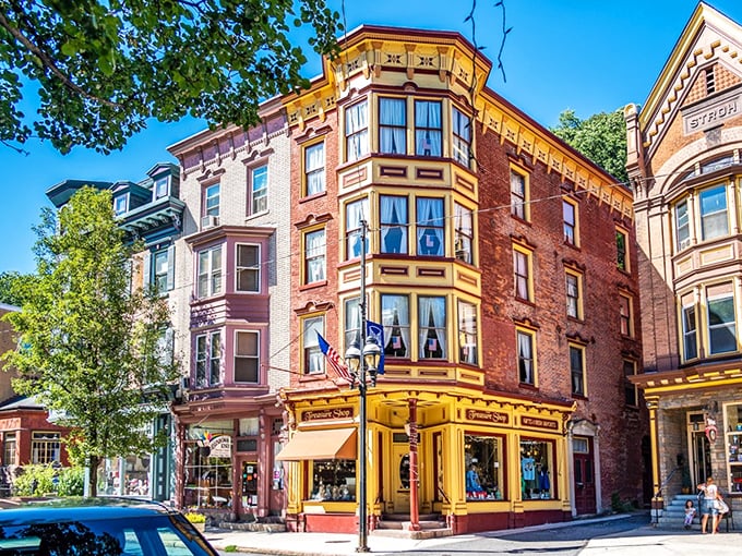 The Treasure Shop's golden storefront gleams like a Victorian jewelry box. Those bay windows practically invite you to press your nose against the glass like an eager child.