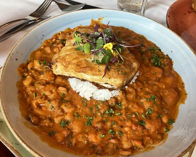 Fish perched atop a sea of beans and rice—a dish that makes you wonder why you'd ever order anything else.