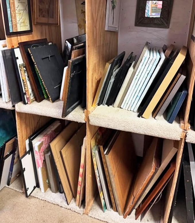 Art and frames stacked like vinyl records in a collector's shop. Someone's discarded wall décor is about to become your conversation piece.