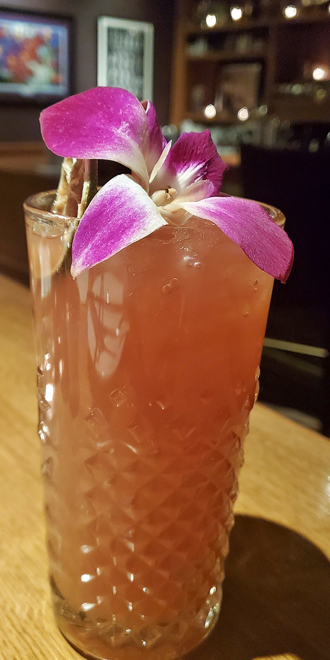This cocktail isn't just garnished with an orchid; it's wearing evening wear to your casual dinner party.
