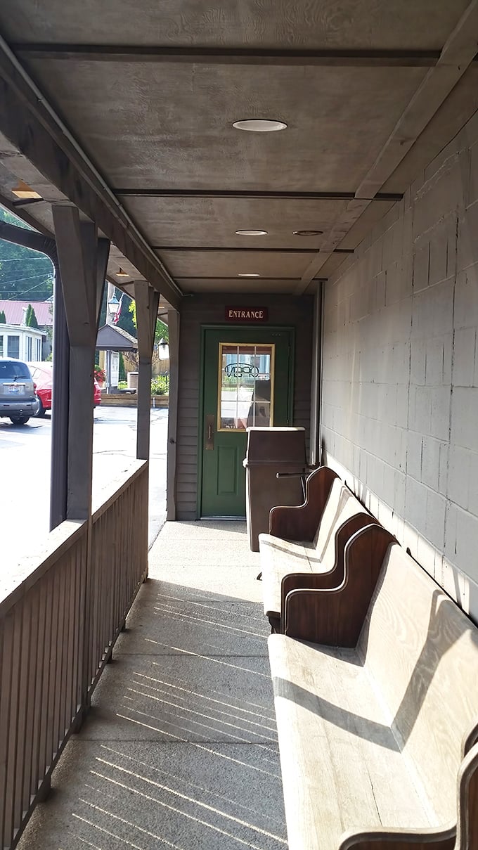 The waiting area's wooden bench isn't just seating—it's where anticipation builds and the aroma of home cooking begins its persuasive argument.