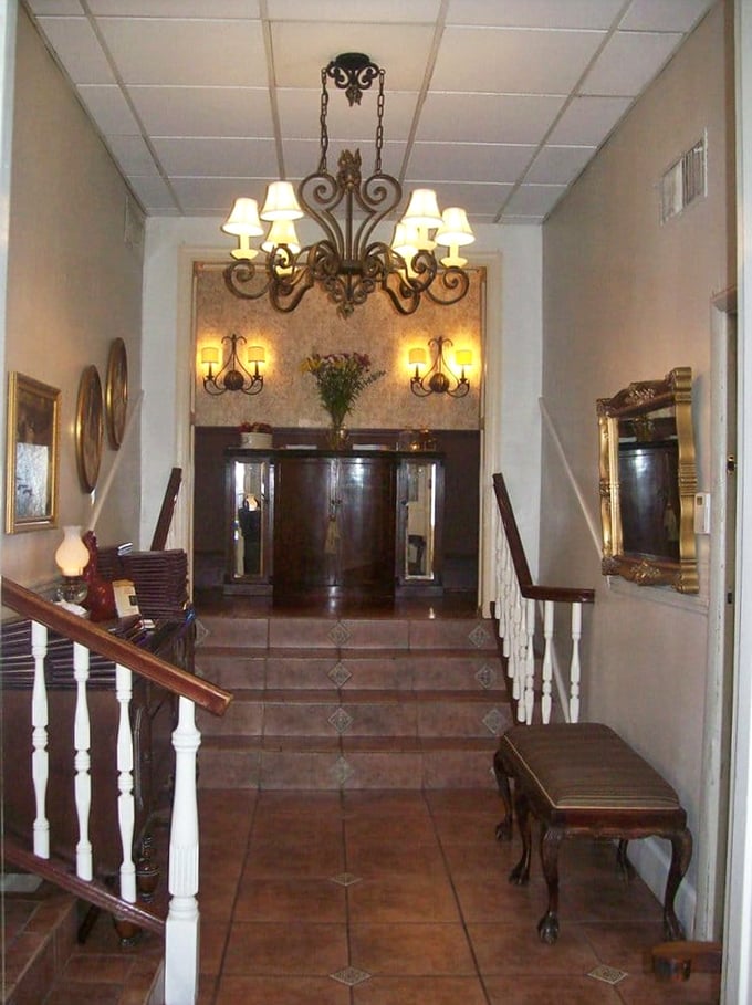 The entrance hallway at Dante & Luigi's feels like stepping into an Italian grandmother's home—if your grandmother had impeccable taste and a chandelier.