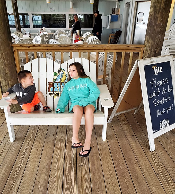 The waiting area doubles as a photo op—that bench with the Blue Parrot logo has starred in more family vacation albums than most celebrities' red carpets.