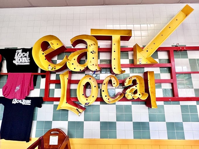 The "eat local" sign isn't just decoration – it's the restaurant's mission statement spelled out in glowing yellow letters.