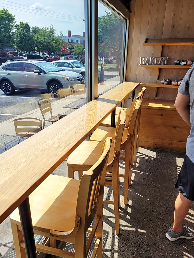 Window seating transforms donut-eating into people-watching, creating the perfect stage for your sugary performance.