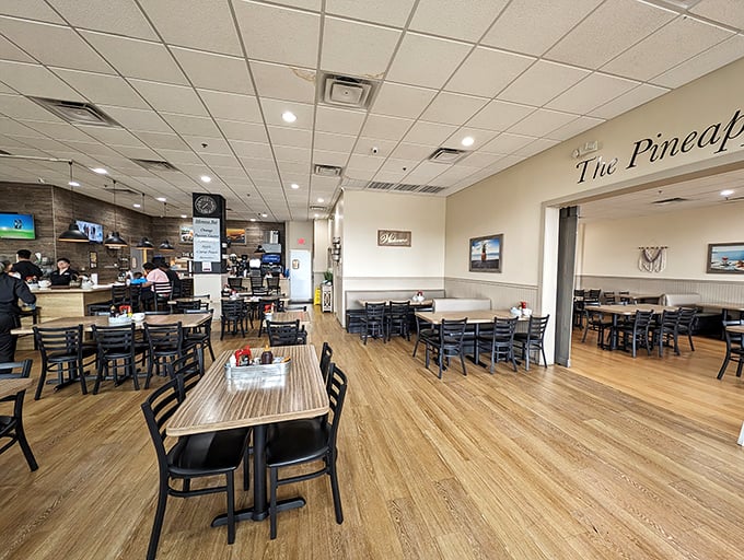 The dining room's warm wood tones and coastal accents create an atmosphere that says "relax, your breakfast is in good hands."