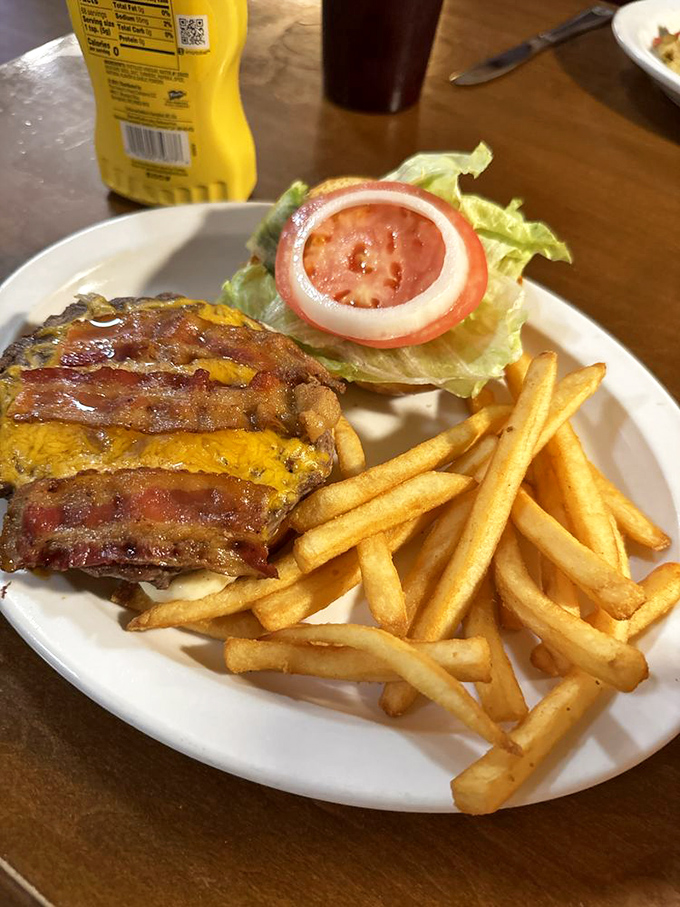 The classic American cheeseburger, perfected. Bacon and cheese melted into submission, with fries that understand their supporting role perfectly.