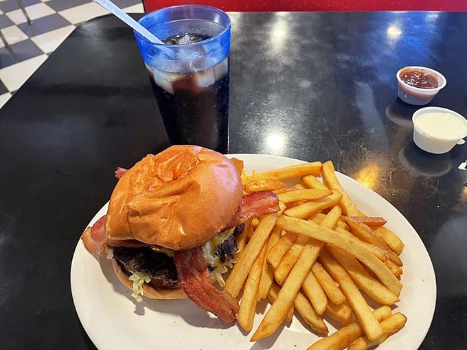 The bacon cheeseburger and fries – a classic American duet performing their greatest hits on a pristine white plate.