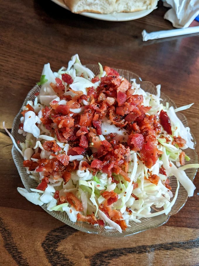 Coleslaw elevated with bacon bits—because in the Midwest, we know everything is better with a sprinkle of pork confetti.