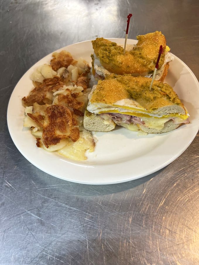 A sandwich built with architectural precision, held together with toothpicks and hope. The home fries are non-negotiable.
