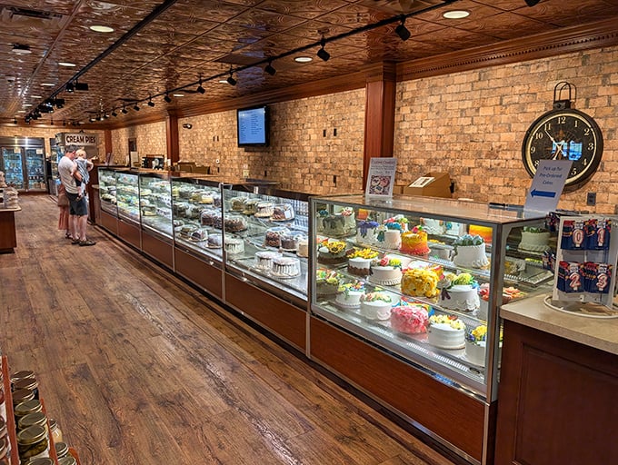 The bakery case stretches toward the horizon like a glass-enclosed museum of edible art. Resistance is futile, and diets come here to die.