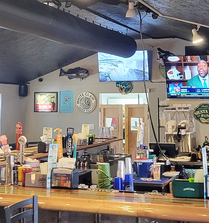 The bar stands ready for thirsty travelers, with fishing memorabilia and cold drinks waiting to wash down that perfect cheeseburger.