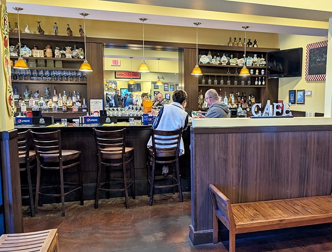 The bar area offers a sophisticated contrast to the homey breakfast vibe – because sometimes your pancakes need a mimosa companion.