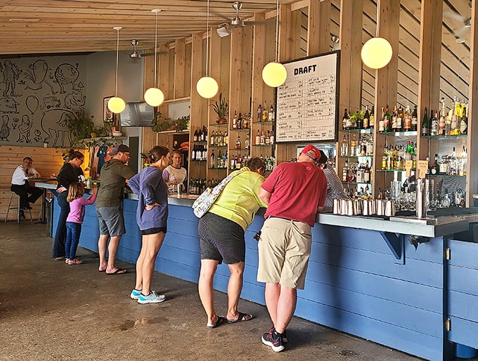 The blue-fronted bar is where the magic happens—where strangers become friends and Michigan craft beers flow like conversation.