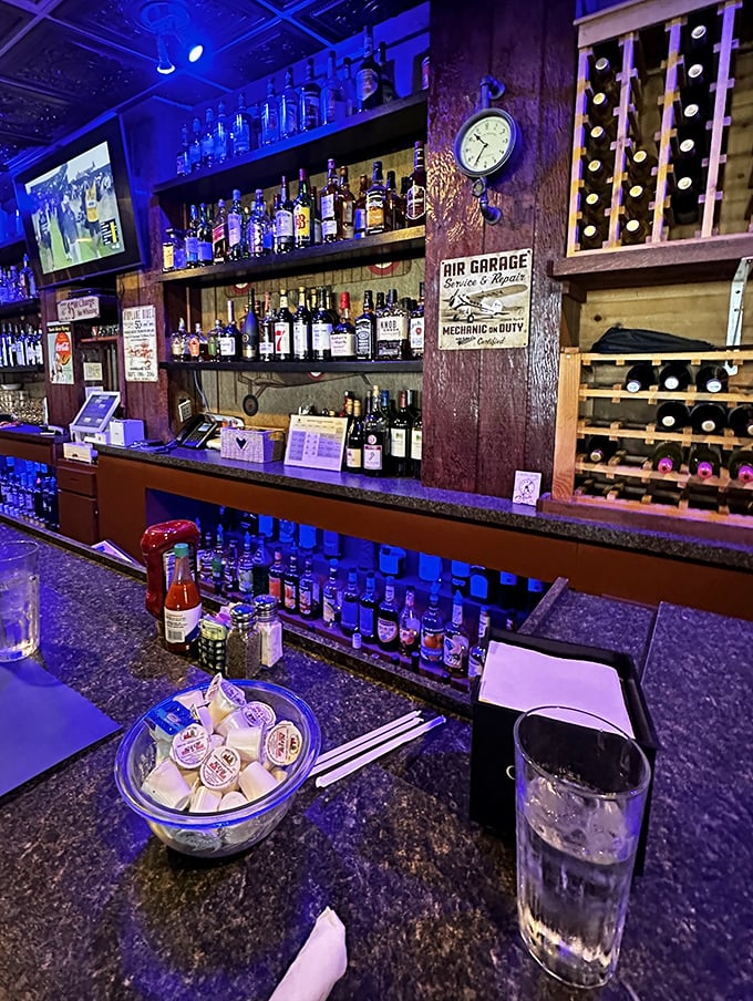 The bar at C.J. Cannon's isn't just serving drinks—it's serving aviation history with a side of ambiance and blue mood lighting.
