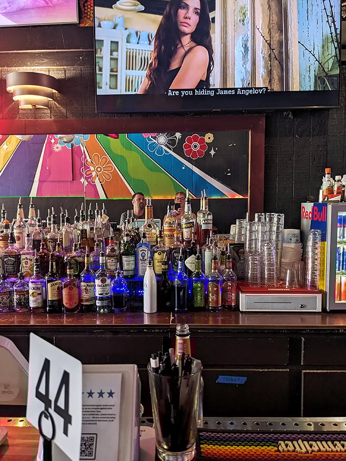The bar at Slammers isn't just stocked—it's an arsenal of good times waiting to happen. That colorful wall art sets the perfect mood.