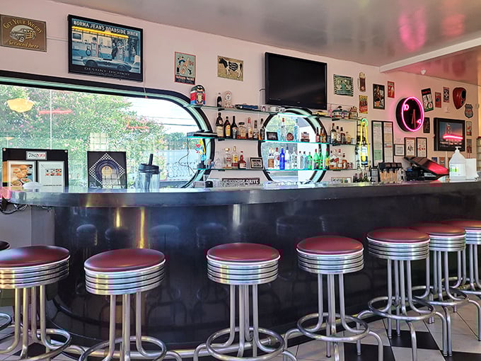The bar area gleams with mid-century charm, offering a front-row seat to the choreographed chaos of diner service.