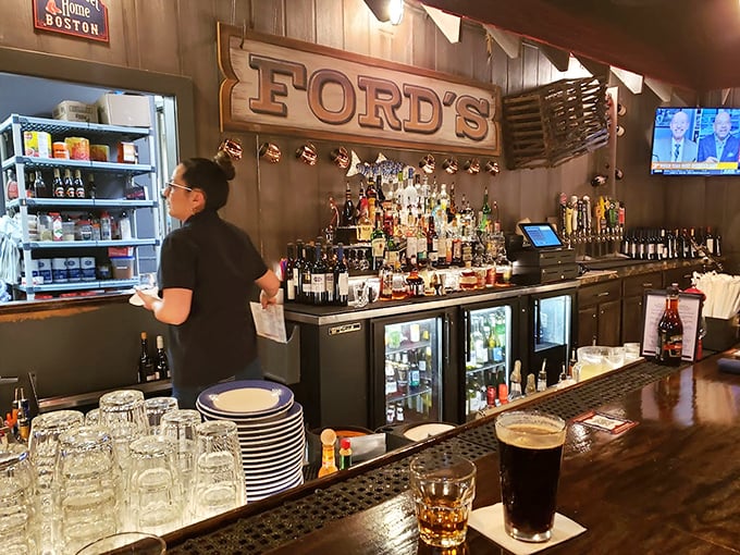 The bar area balances nautical charm with serious libations. That wooden "FORD'S" sign has witnessed countless toasts to good catches – both seafood and first dates.