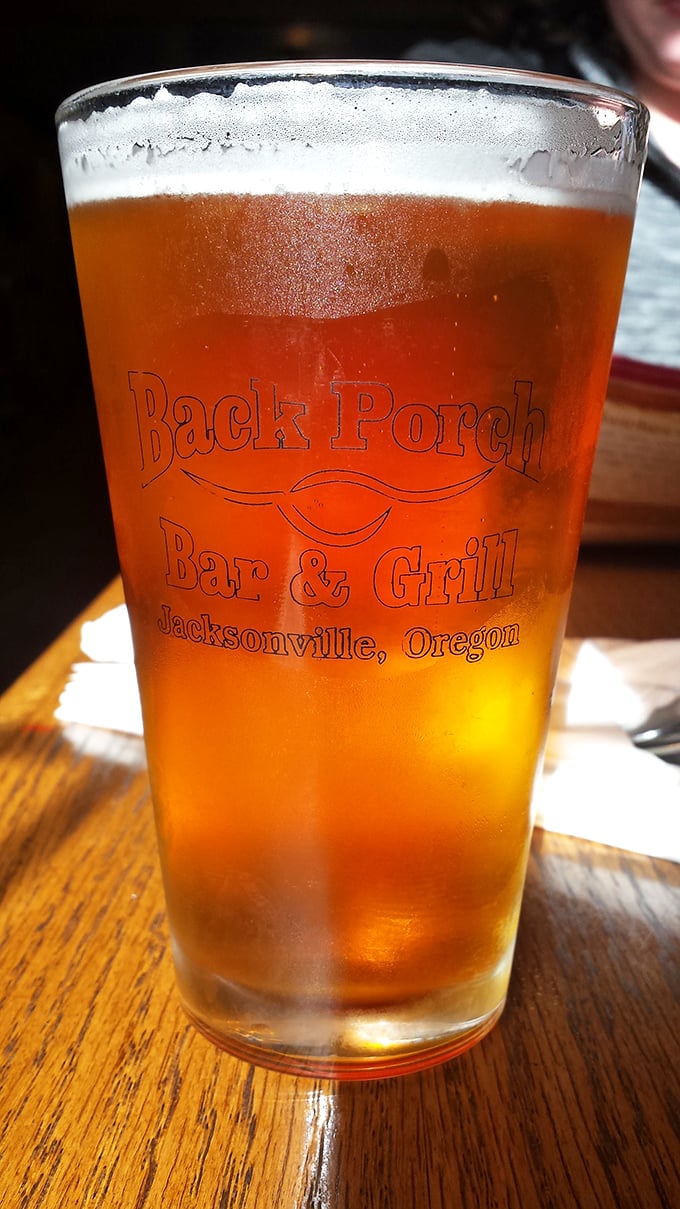 A perfectly poured local brew in custom glassware—because great barbecue deserves an equally thoughtful beverage companion.
