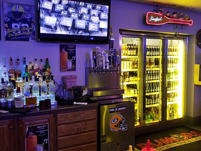 The bar gleams with promise – bottles standing at attention, ready to pour liquid courage before you attempt karaoke on Thursday nights.