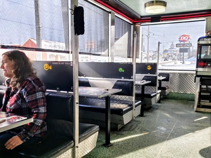 Booths lined up like old friends waiting for your stories—each one a private dining room with a view of small-town America passing by the windows.