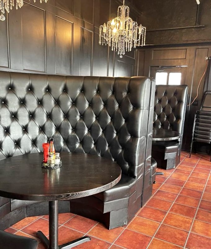 Tufted leather booths under crystal chandeliers create unexpected elegance—like your sophisticated aunt who still knows how to party when the occasion calls.