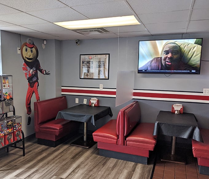 Booth seating where Ohio State pride isn't just decoration—it's practically a religion. That Brutus Buckeye mural watches over diners like a scarlet and gray guardian angel.