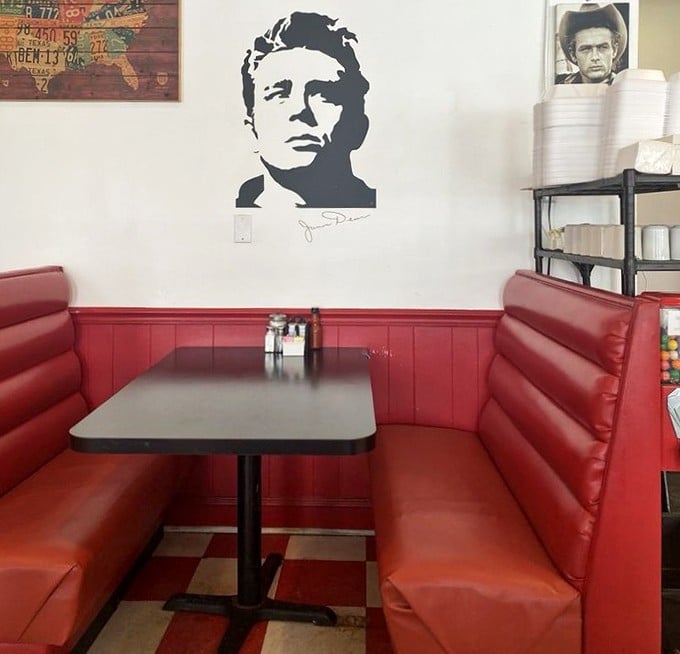 The corner booth beneath James Dean's watchful gaze—where you can channel your inner rebel while conforming to the very American tradition of breakfast indulgence.