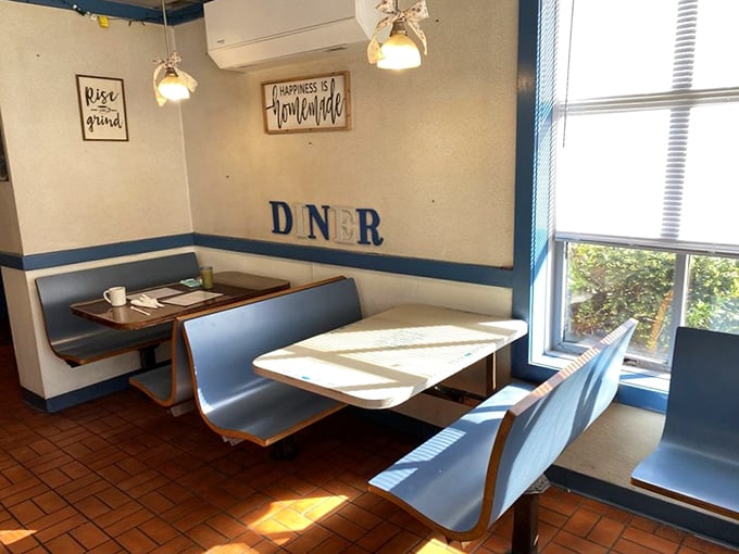 Classic blue booths bathed in morning light – each one a private breakfast sanctuary for coffee contemplation.