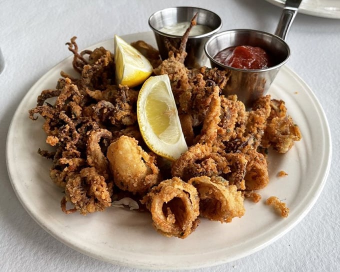 Calamari that crackles with golden perfection – tender within, crispy without, and impossible to stop eating once you start.