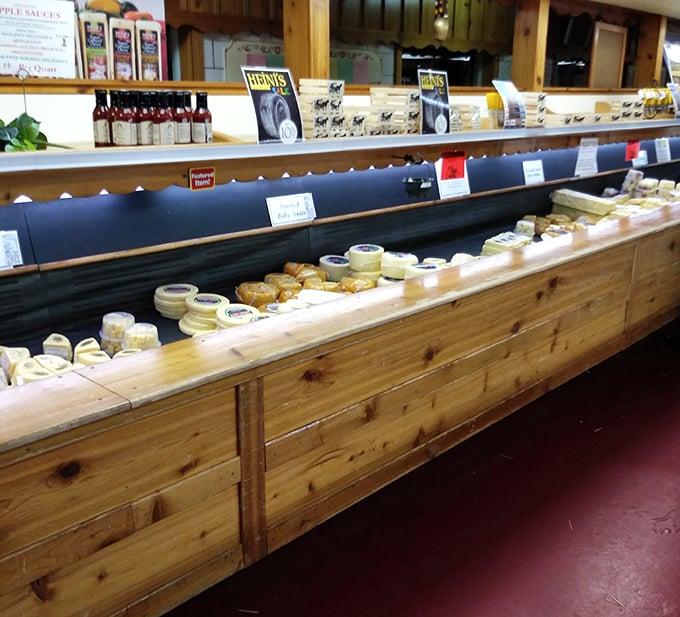 The cheese counter—where dairy dreams come true. This wooden display case has launched thousands of perfect sandwiches and countless impromptu cheese board gatherings.