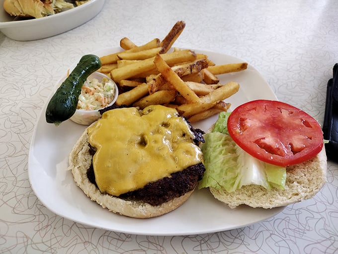 The cheeseburger that reminds you why classics became classics. That pickle spear standing at attention is the exclamation point on a perfect plate.